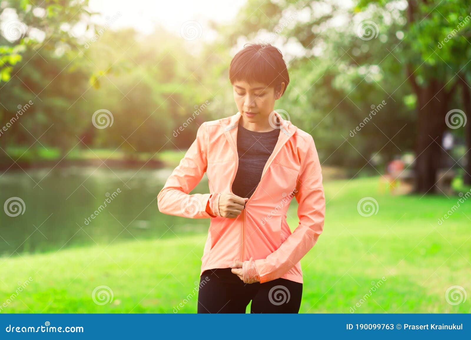 Woman Zipping Zip Up before Excercise Stock Image - Image of active ...