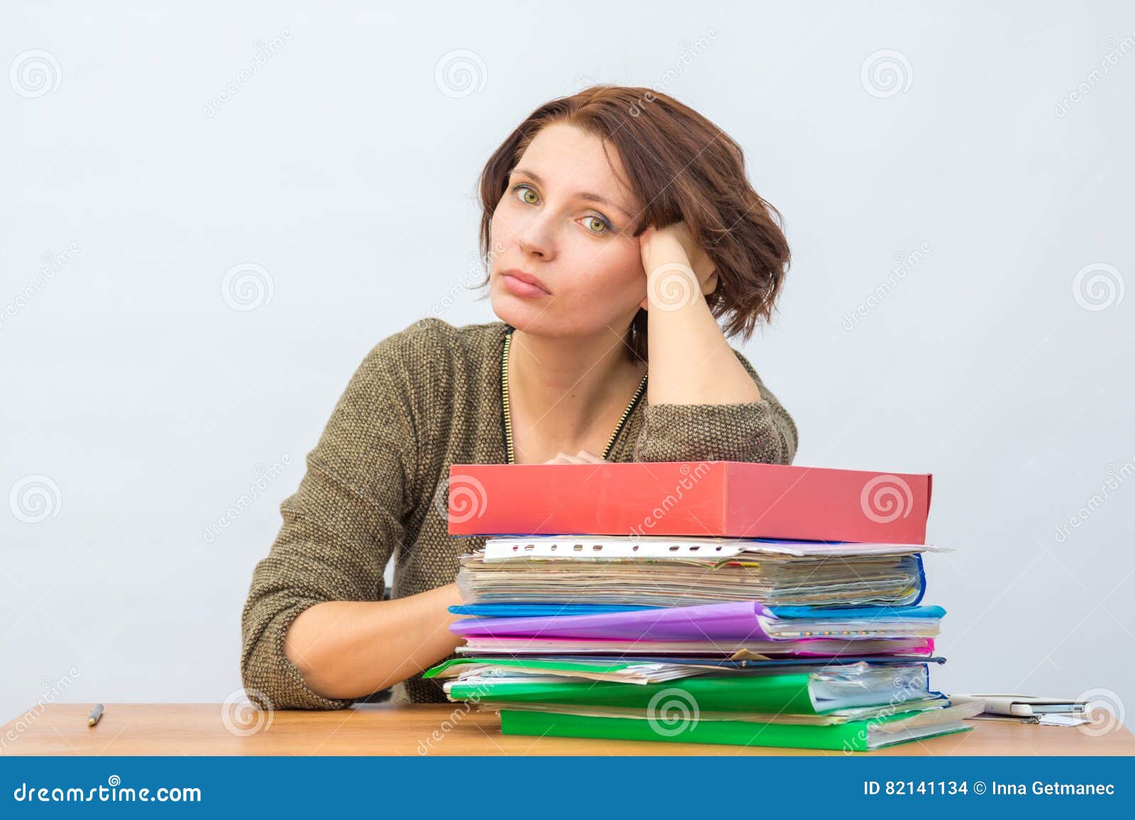 Womanl Office Staff Thoughtfully Leaning on a Stack of Folders Stock ...