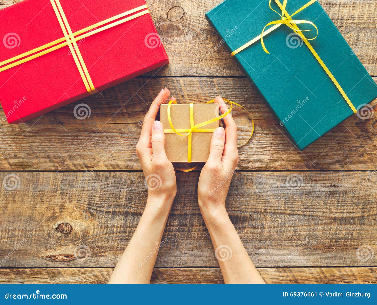 Womans Hand Holding Craft Gift Box on Wooden Table Stock Image - Image ...