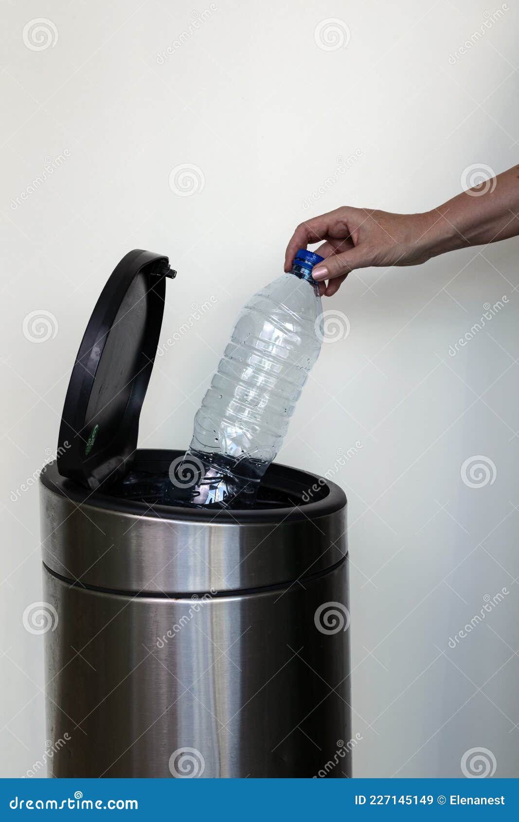 A Woman S Hand Throwing Out a Plastic Bottle in a Rubbish Bin Stock ...
