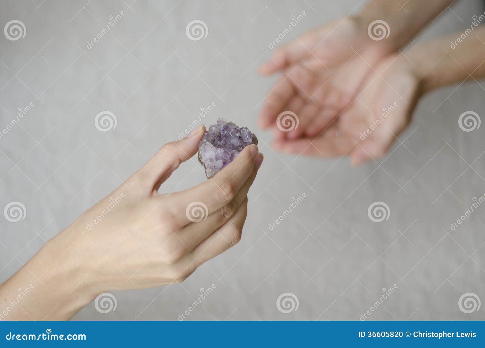 Womans Hands Giving an Amethyst Crystal To Another Stock Photo - Image ...
