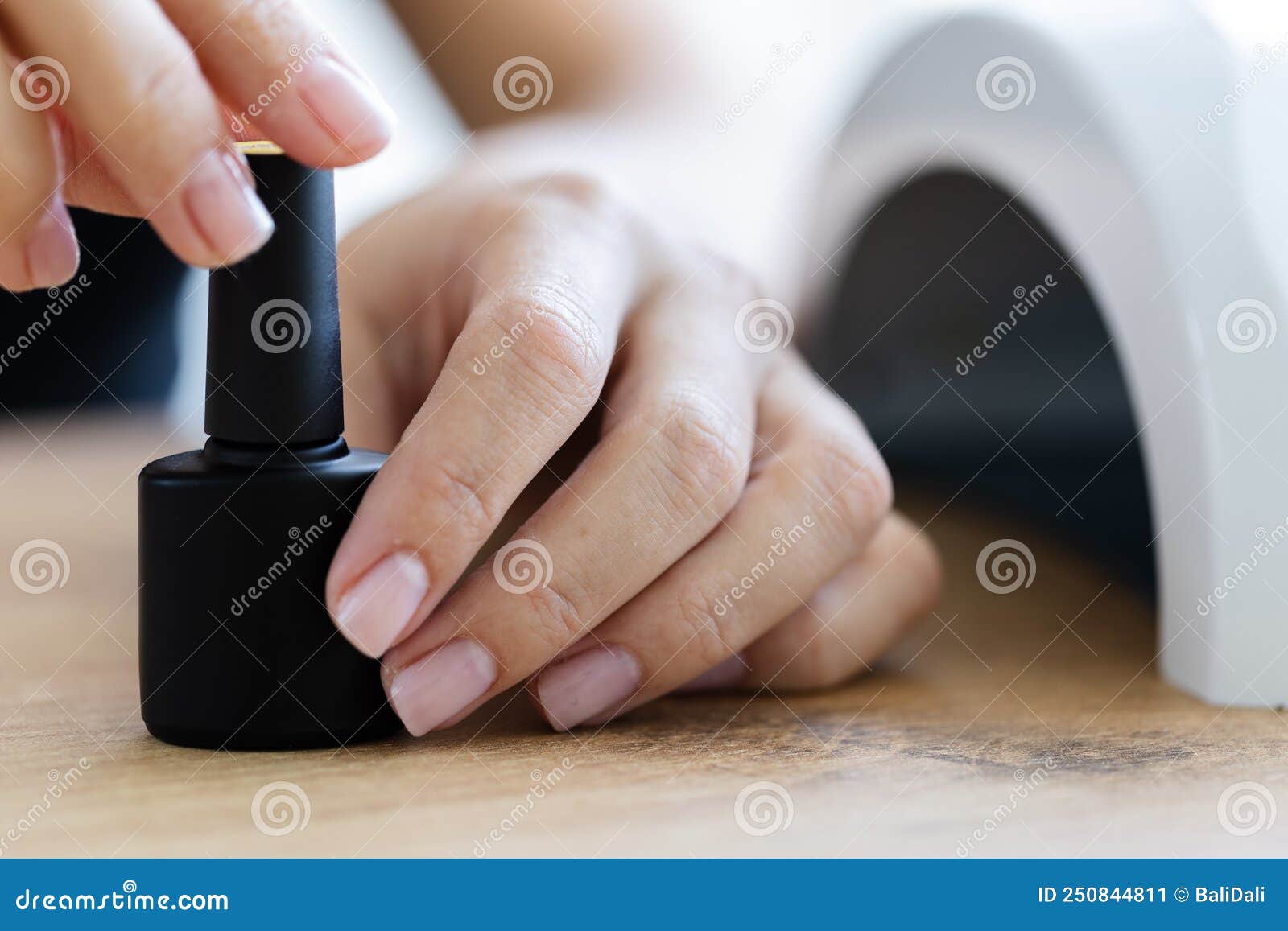Womans Hands Holding Black Bottle of Shellac. Manicure Concept Stock ...