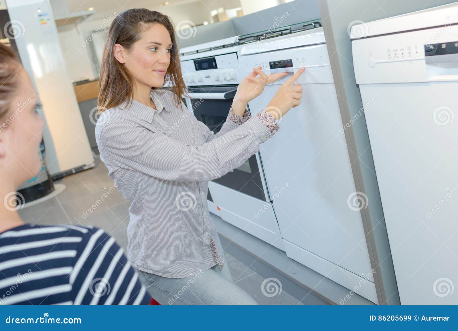 Women in appliance shop stock image. Image of features - 86205699