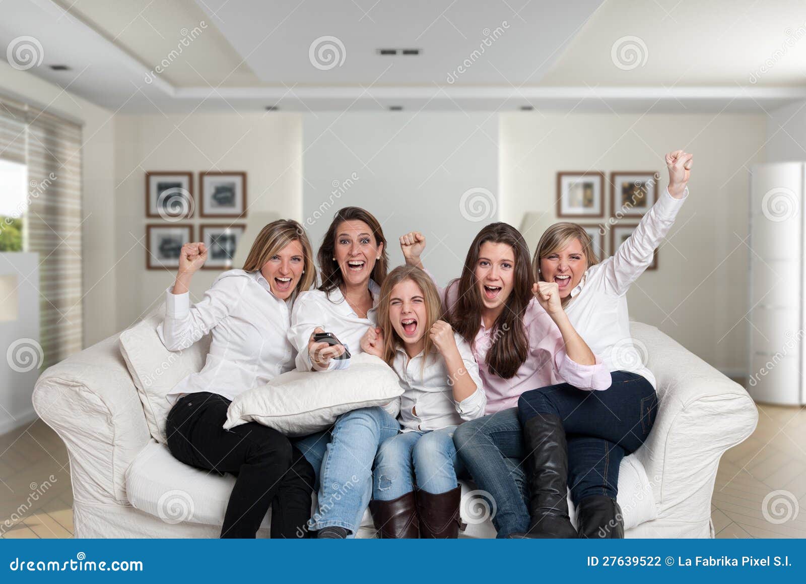 Women cheering on the sofa stock photo. Image of bliss - 27639522