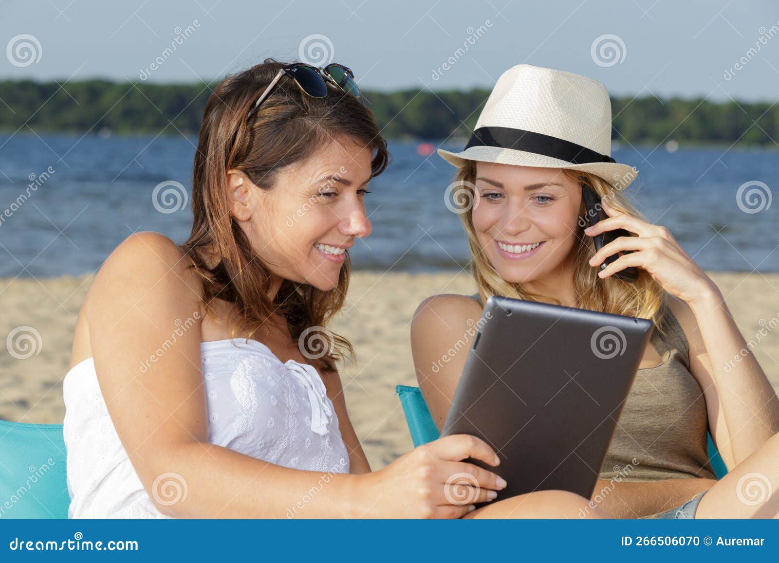 2 women connected on beach stock photo. Image of summer - 266506070