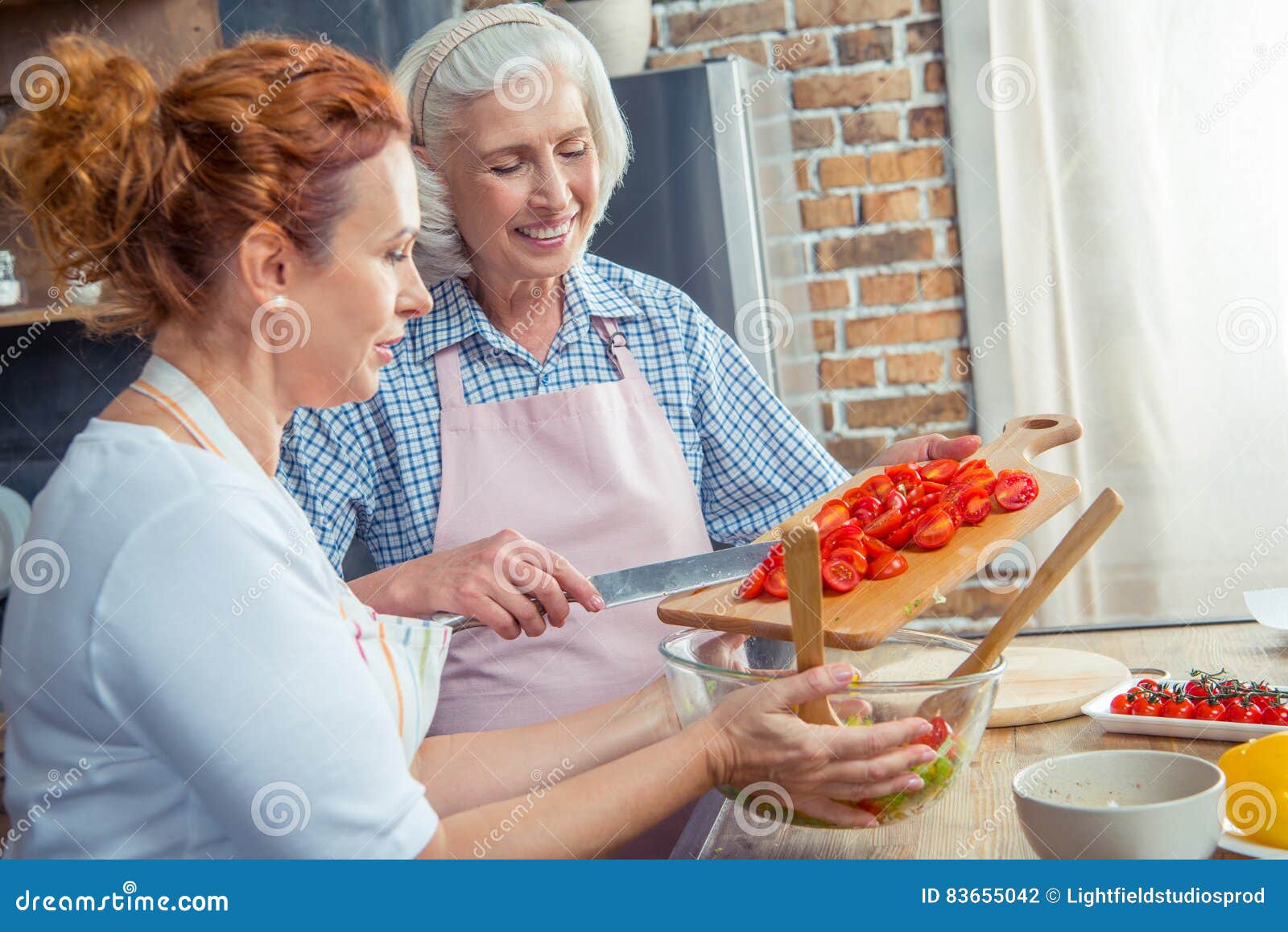 Women cooking together stock photo. Image of generations - 83655042