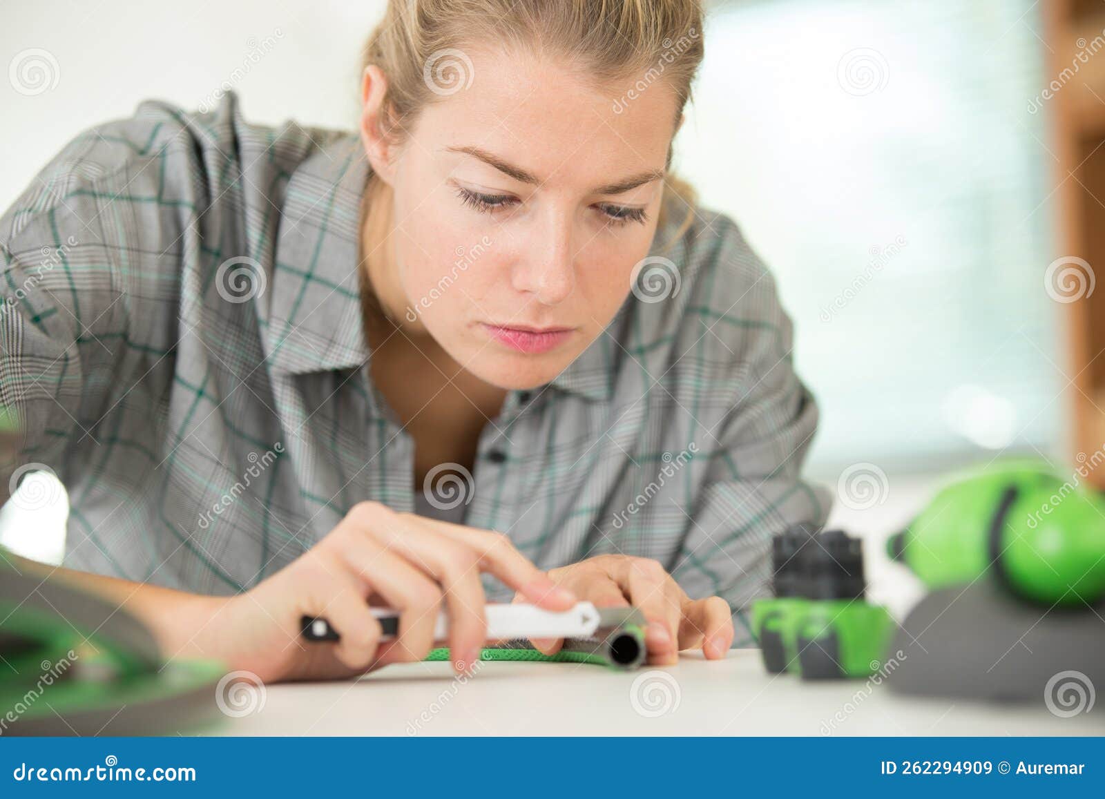 Women cutting pvc pipe stock image. Image of sawing - 262294909
