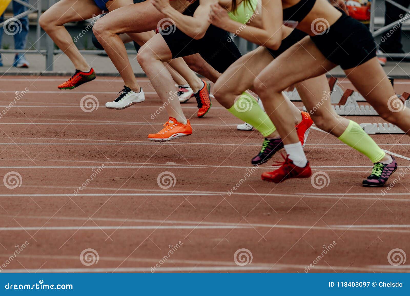 Women Sprinters At Starting Position Ready For Race On Racetrack