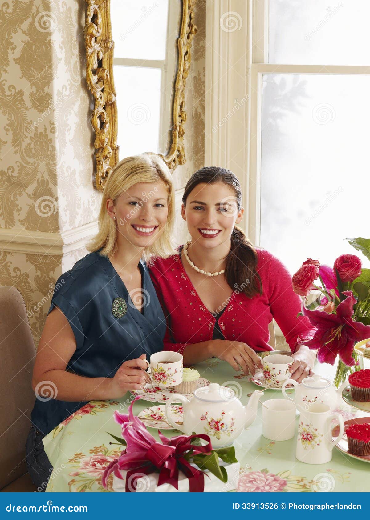 Women Having Tea at Dining Table Stock Photo - Image of holding ...
