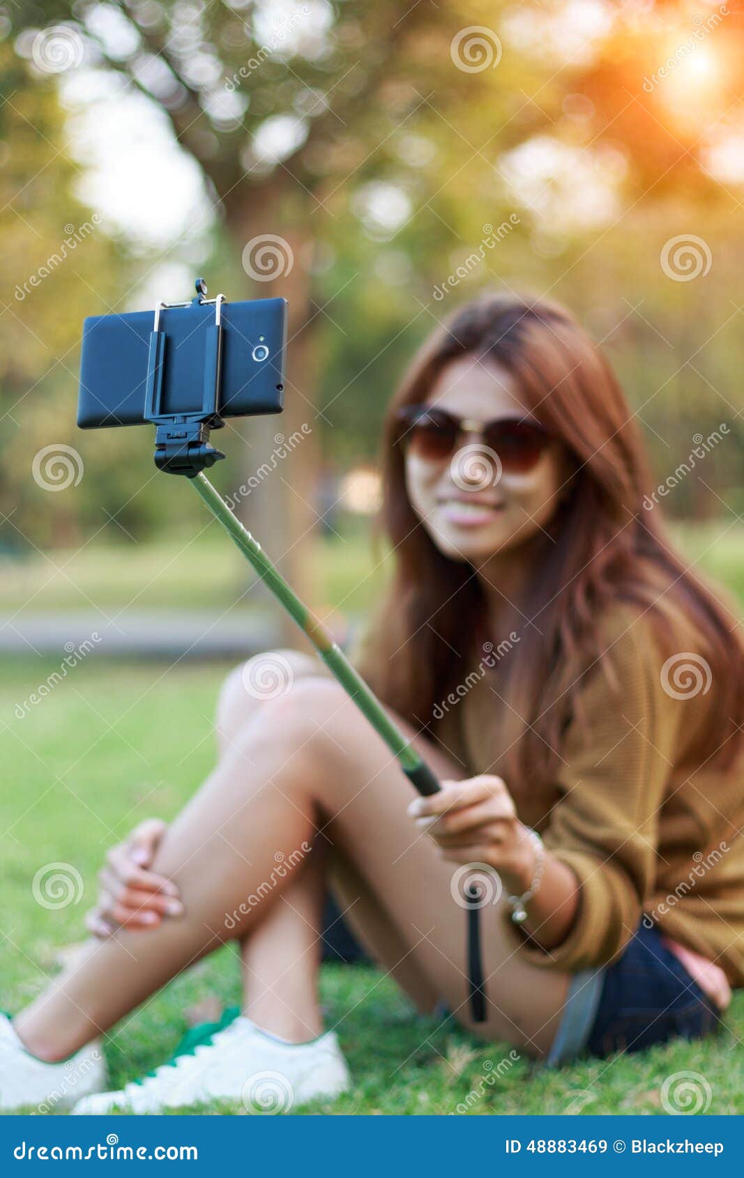 Women Hold Monopod Use Smart Phone Take Photograph Selfie In Park Stock