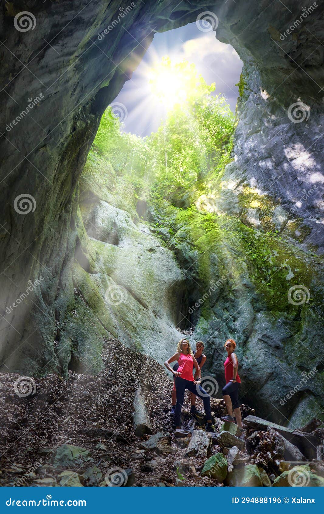 Women Inside a Cave with Sun Shining Above Stock Photo - Image of ...