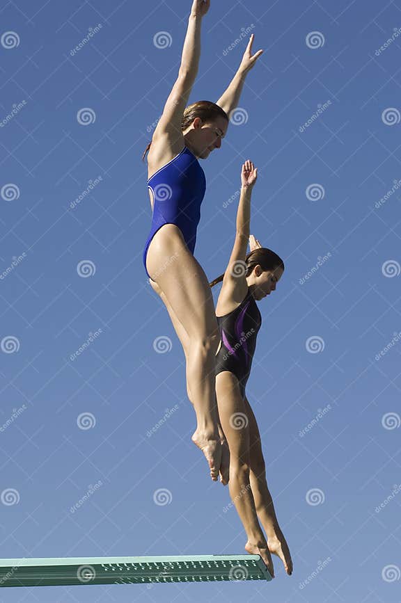 Women Jumping from Dive Board Stock Photo - Image of pool, jump: 29649044
