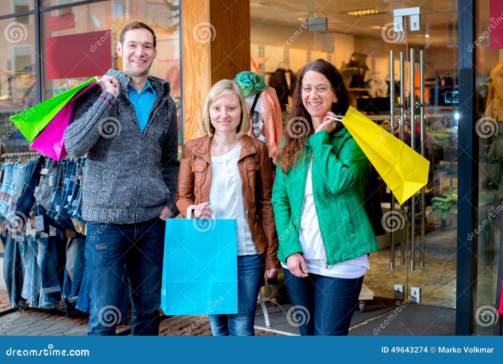 Women and a Man in Front of Clothes Shop Stock Photo - Image of apparel ...