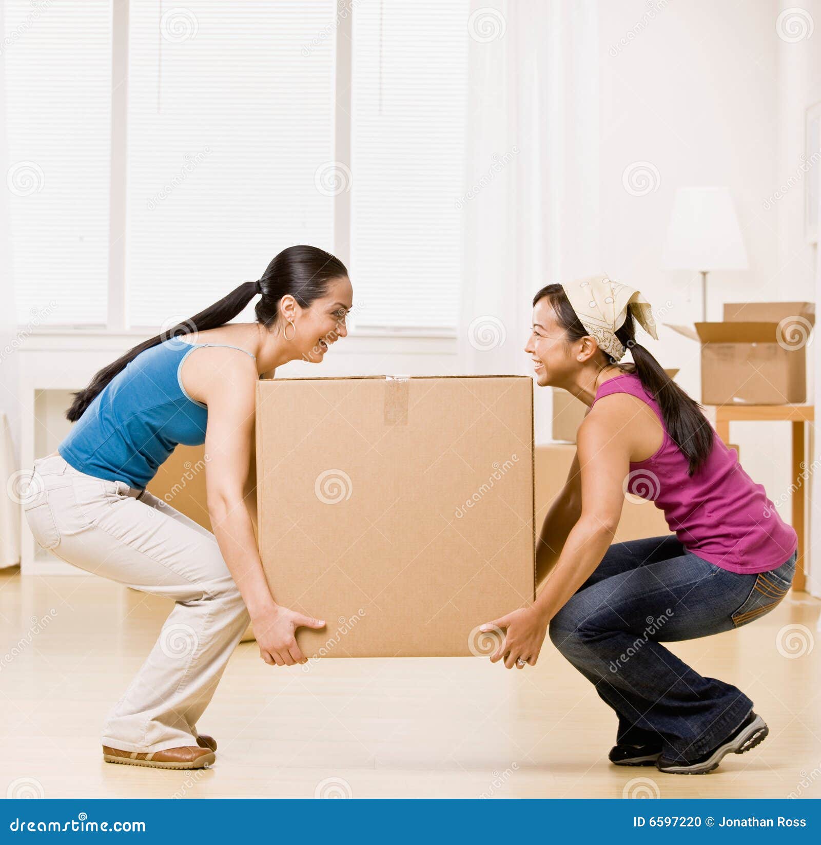 Women Moving into New Home and Carrying Box Stock Photo - Image of ...