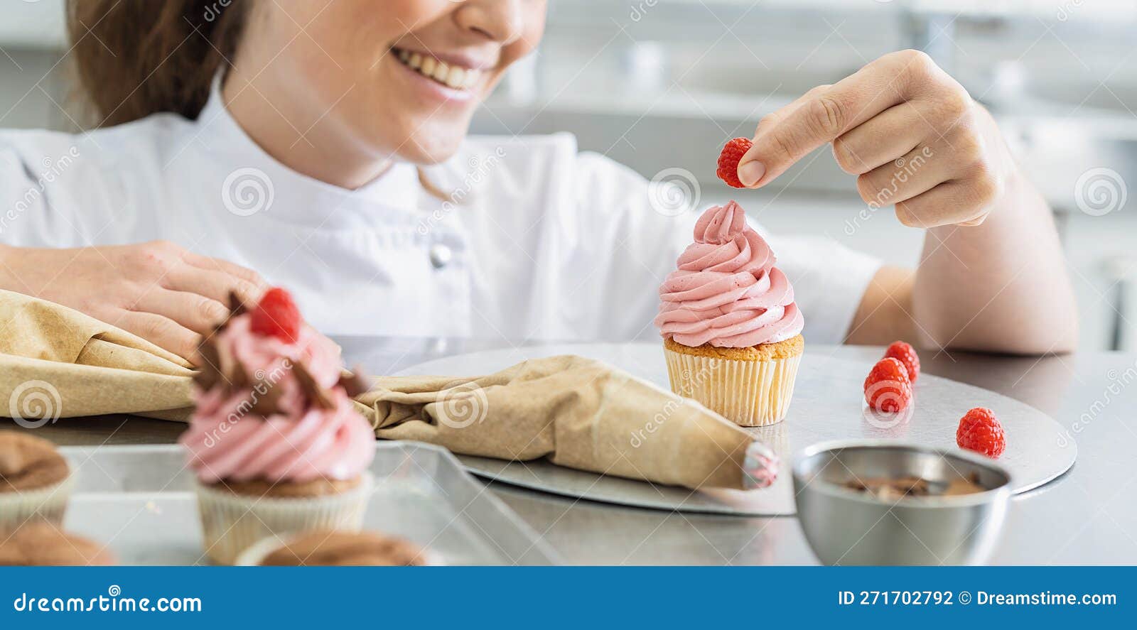 Women in Pastry Bakery Working on Muffins Putting a Raspberry on Top ...