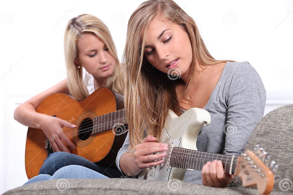 Women playing the guitar. stock image. Image of guitar - 26795753