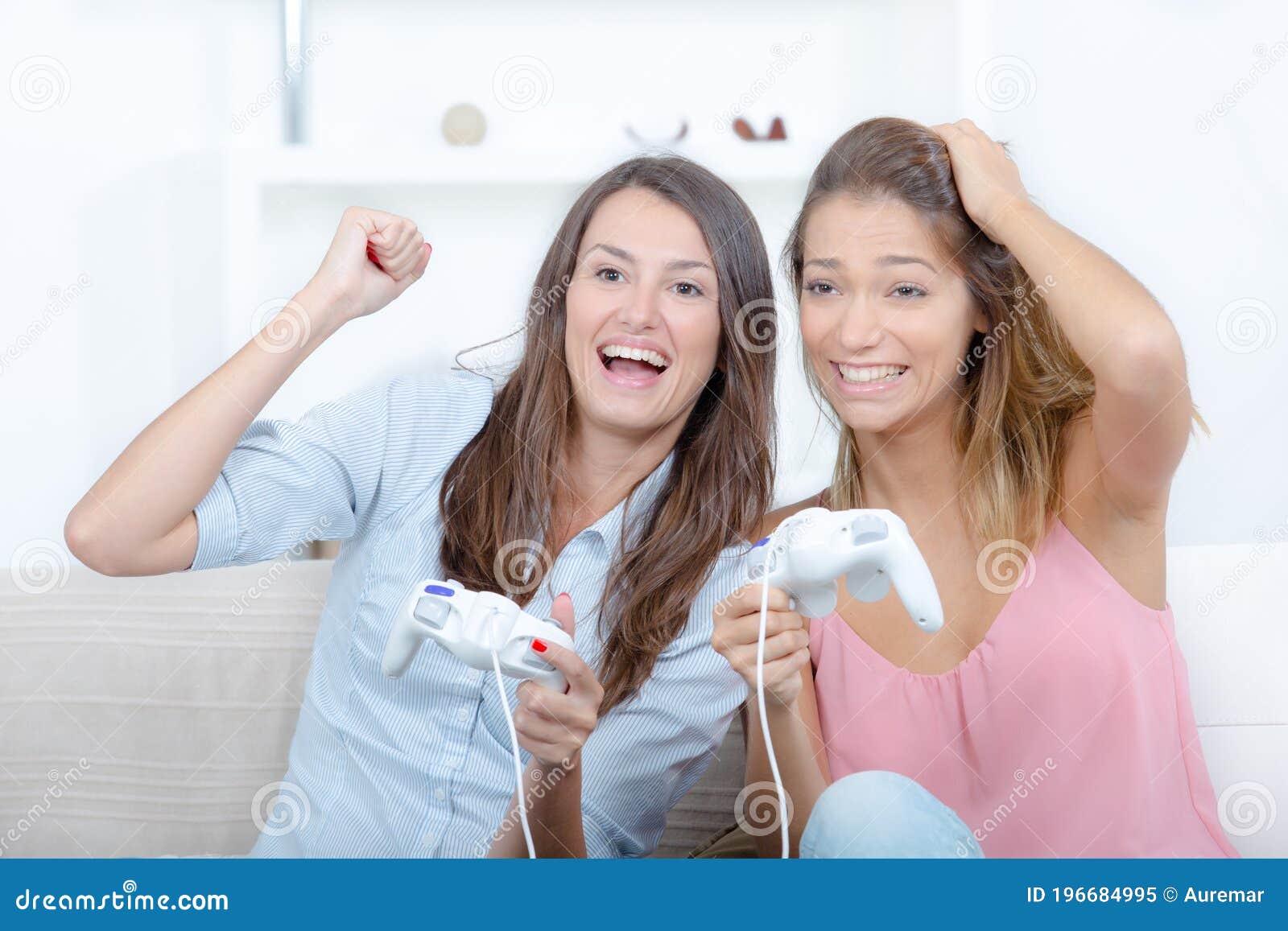 2 women playing video game stock image. Image of device - 196684995