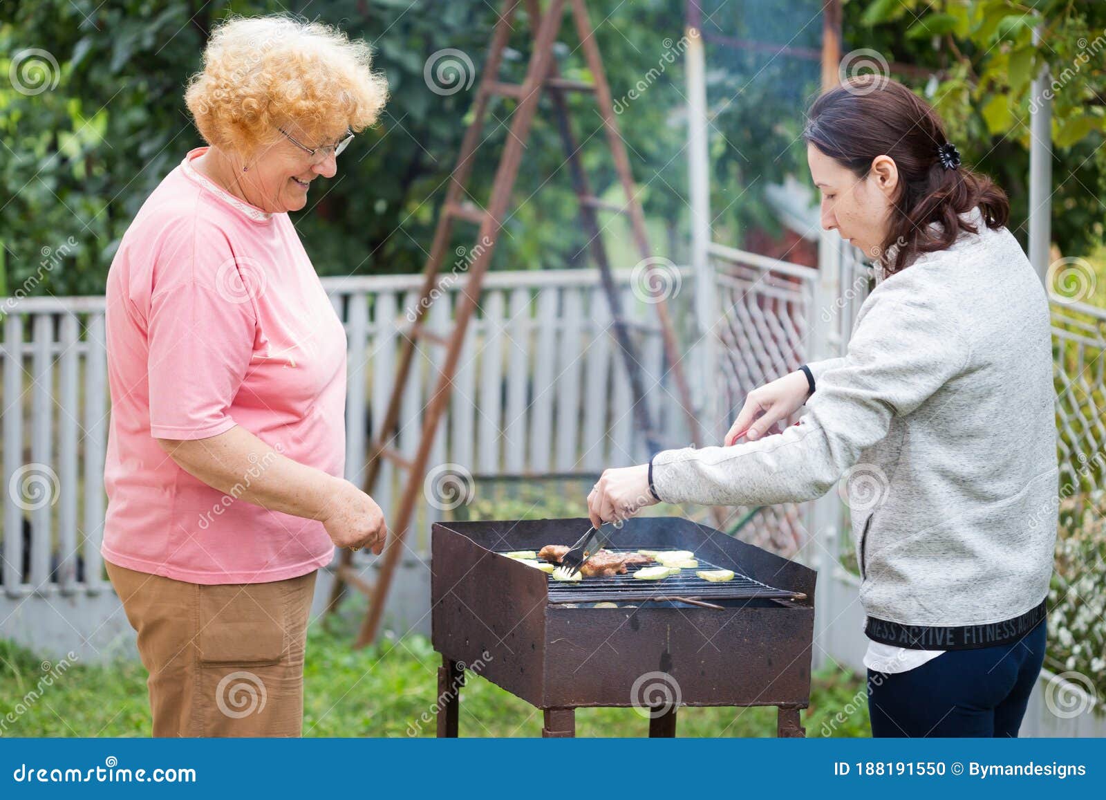 Women Preparing the Barbecue Outside Stock Photo - Image of grilling ...