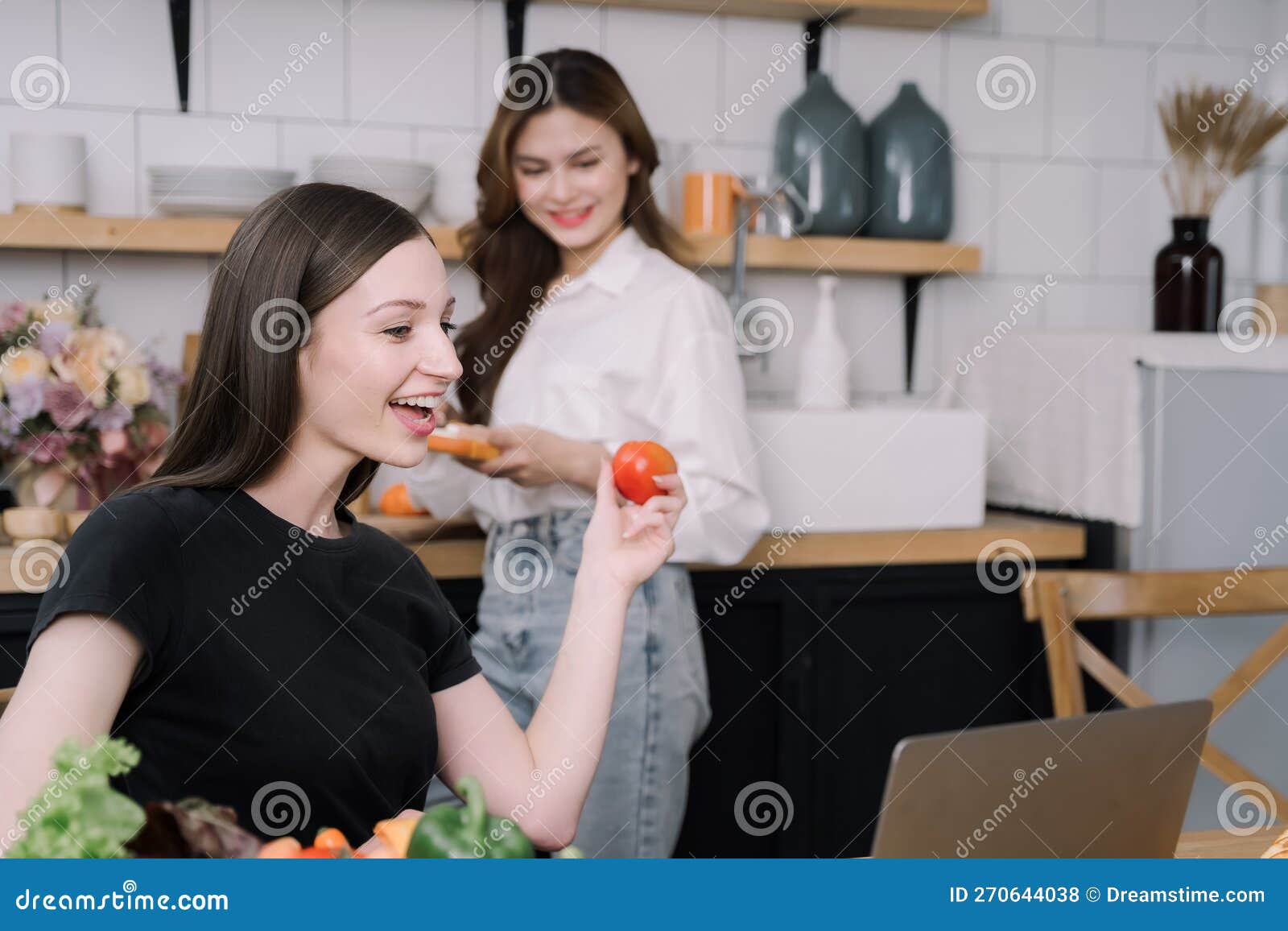 Women Preparing Food Playing with Vegetables and Bread in Kitchen ...