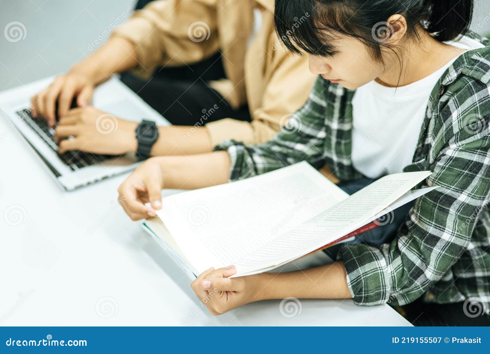 Women Read Books and Men Use Laptops To Search for Books in Libraries ...