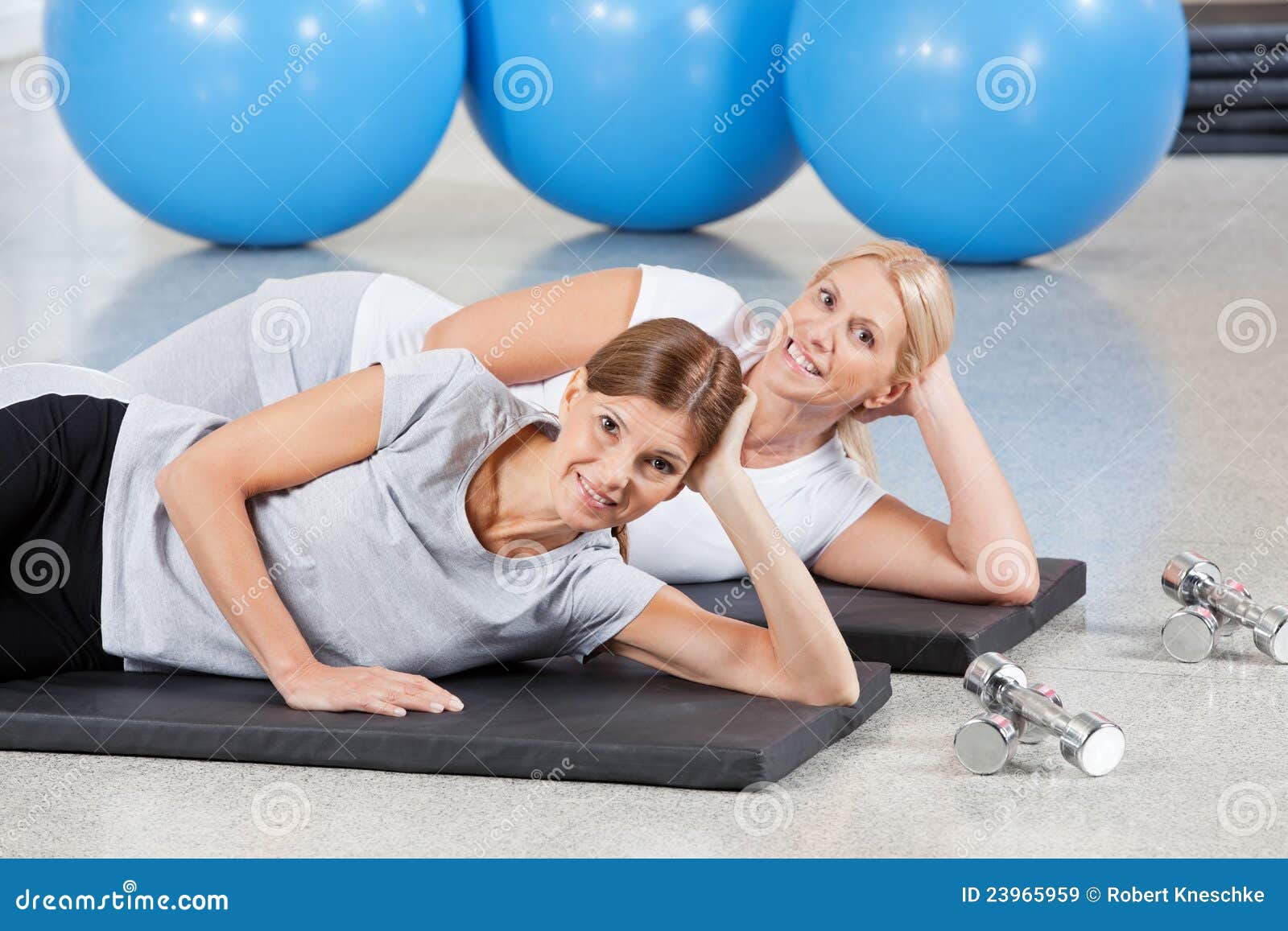 Women relaxing on gym mats stock image. Image of body - 23965959