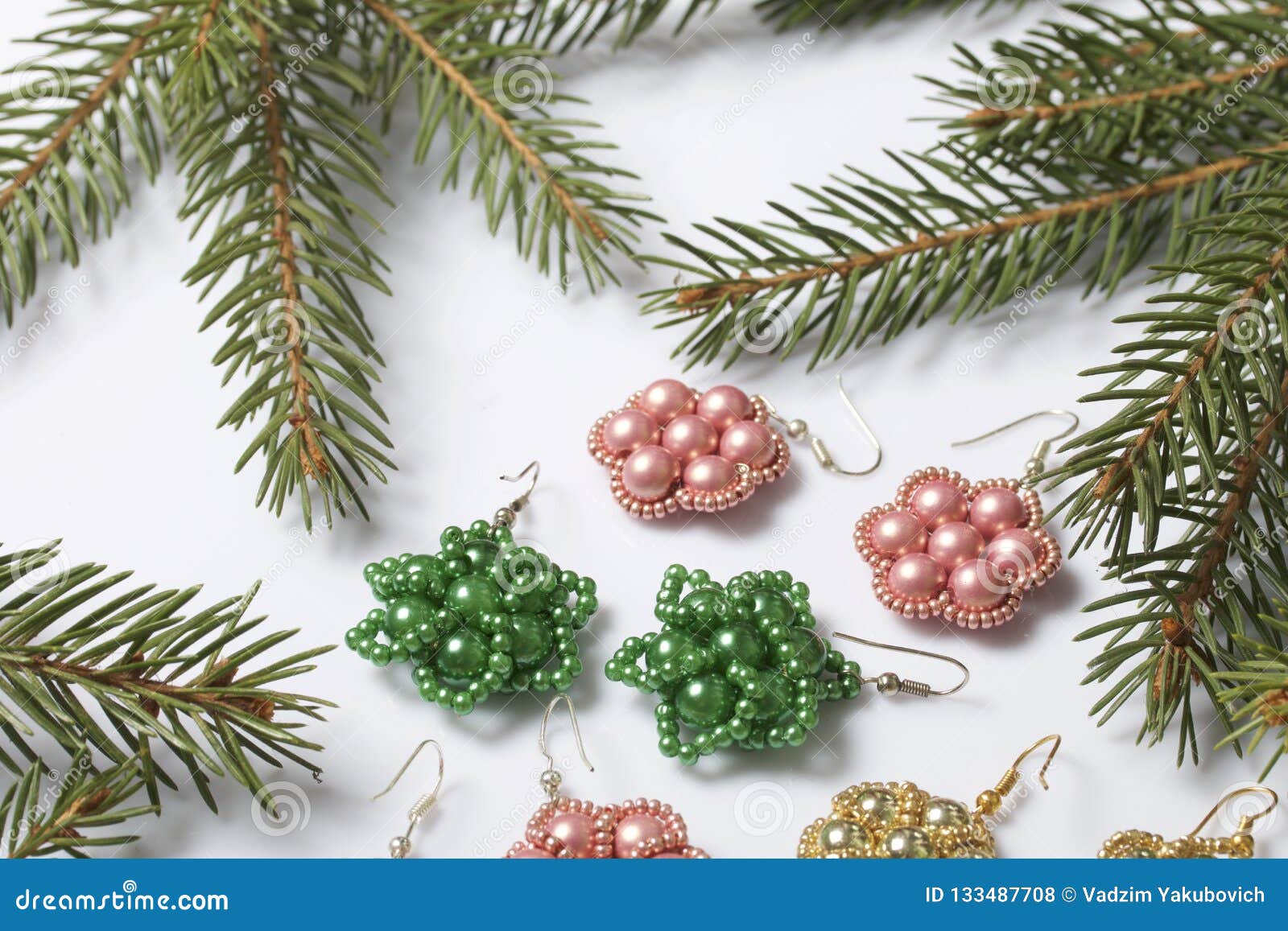 Women`s Earrings Made of Beads among the Branches of Spruce. Stock ...