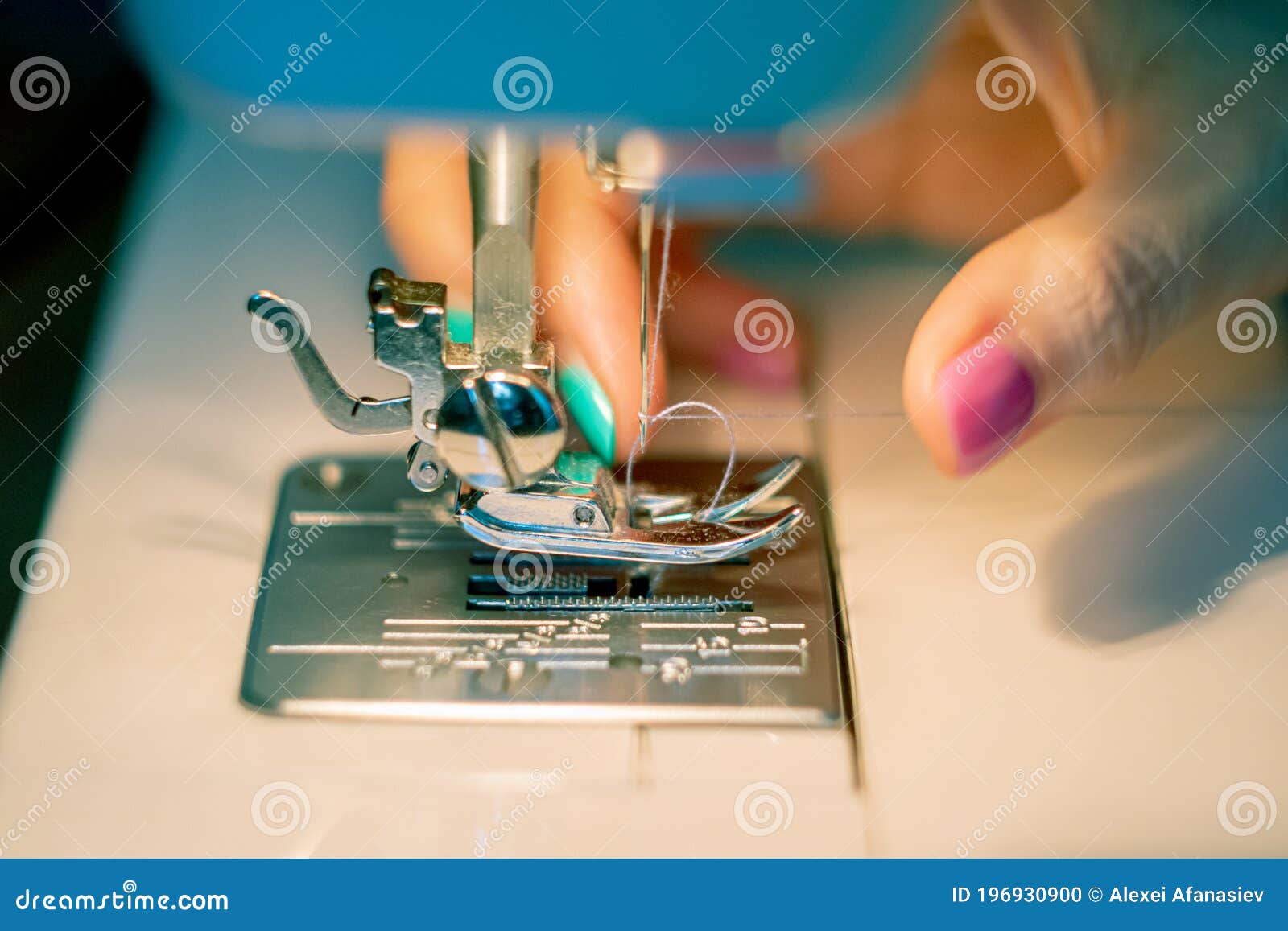 Women`s Fingers Thread the Needle of a Sewing Machine. Close Up. Soft ...