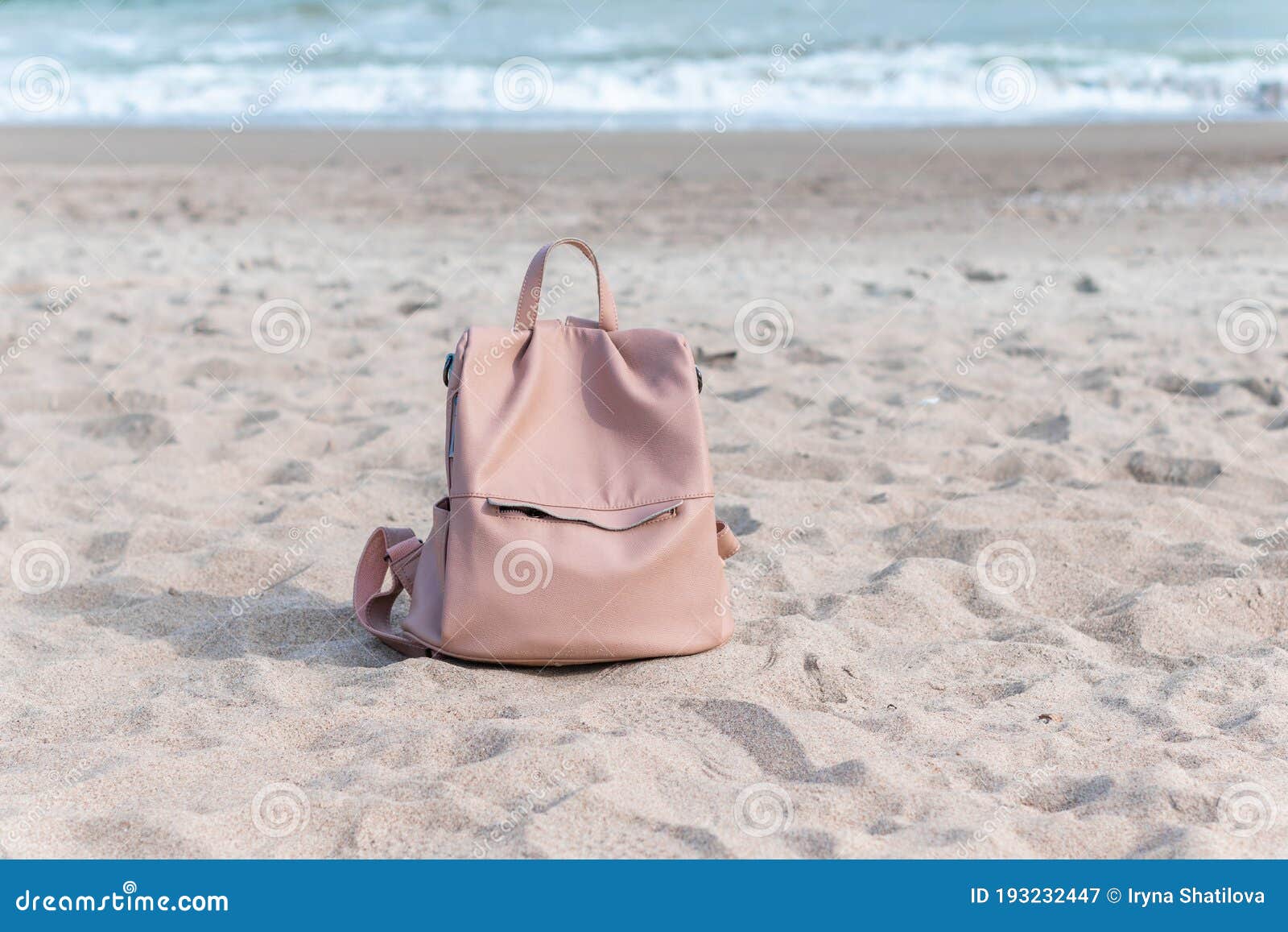 Women`s Pink Backpack on the Beach with an Ocean View Stock Image ...