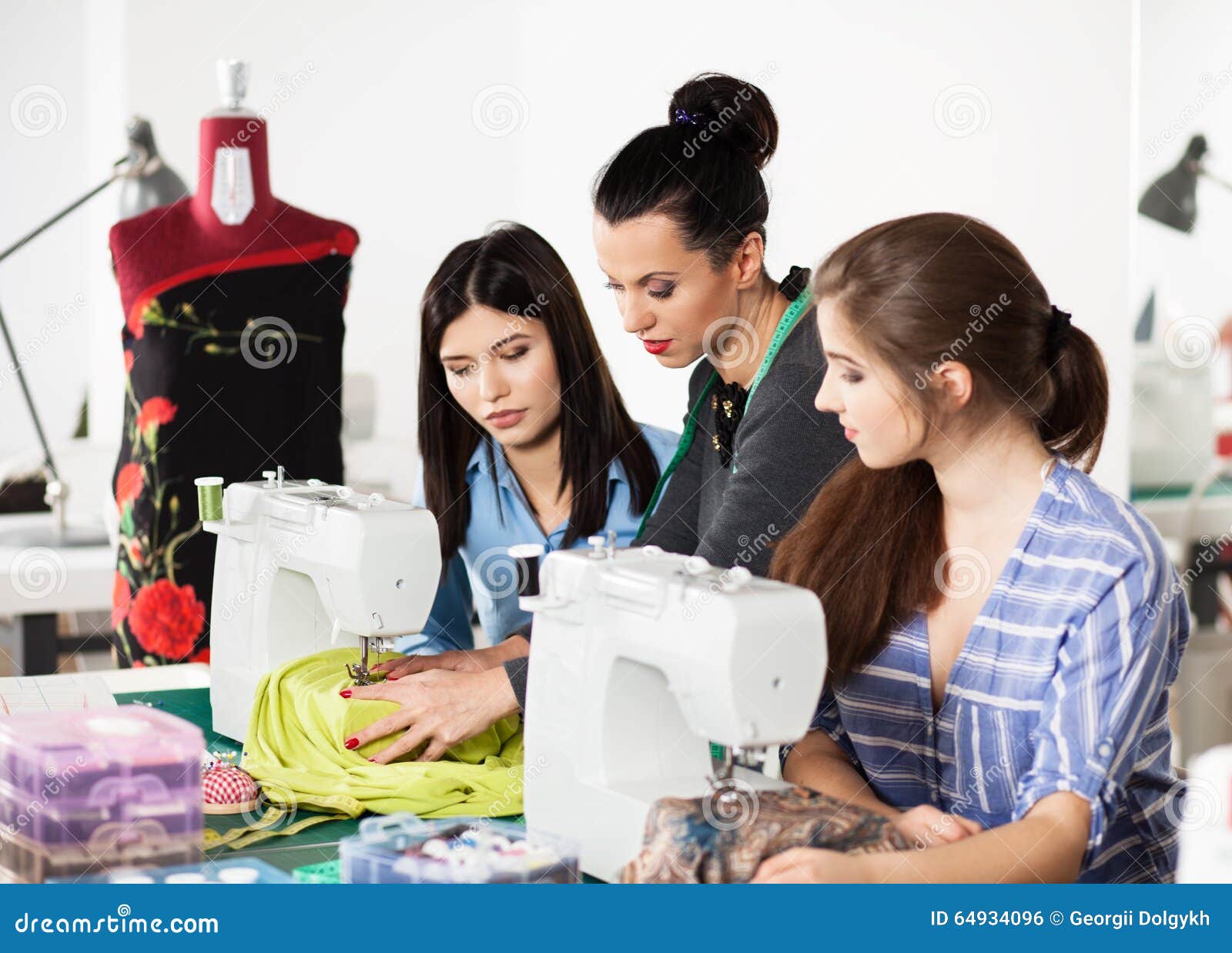 Women in a sewing workshop stock photo. Image of fashion - 64934096