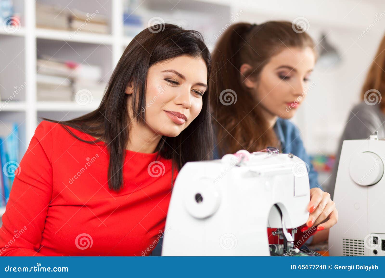 Women in a sewing workshop stock photo. Image of designer - 65677240