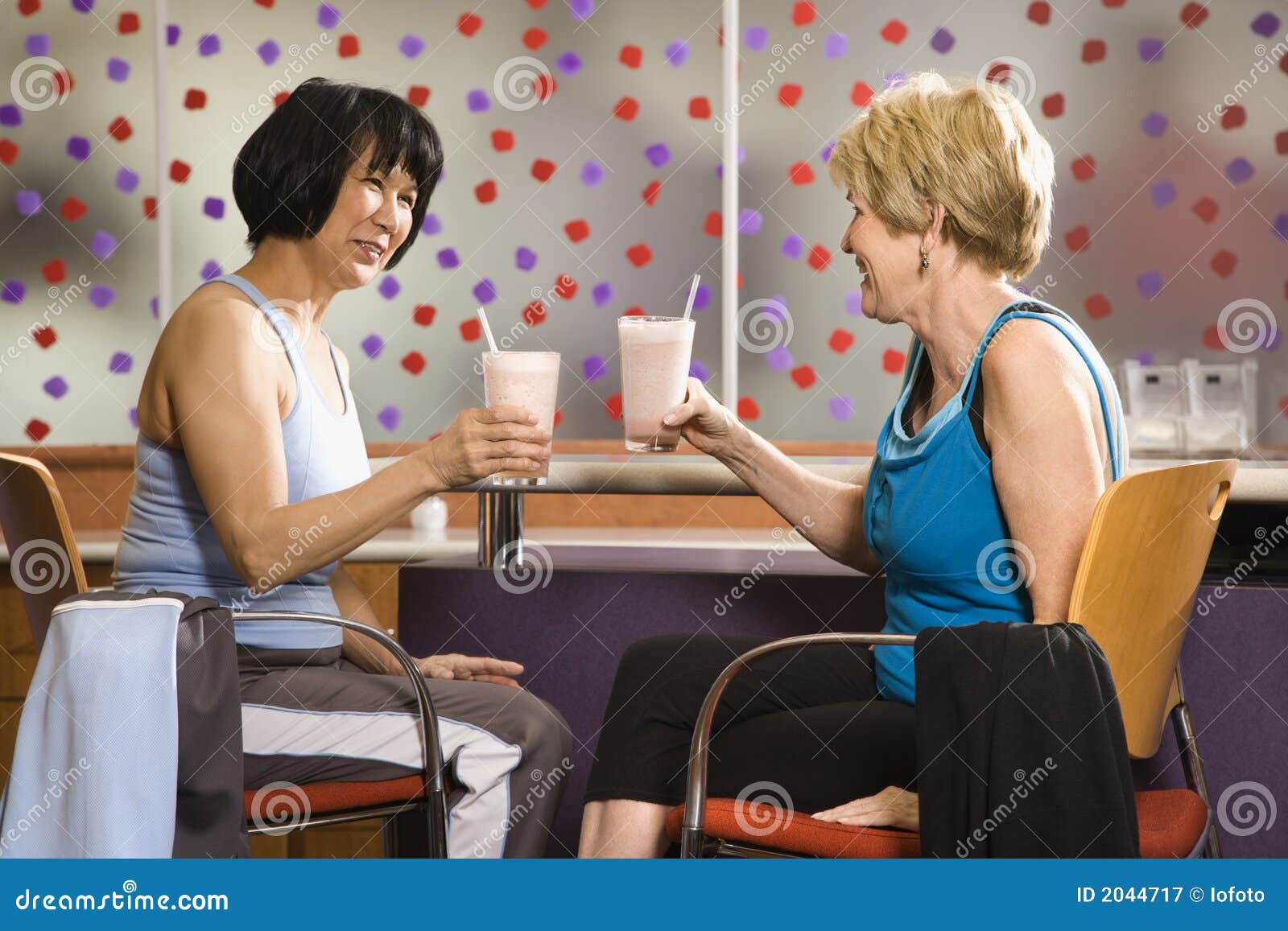 Women sitting with drinks. stock image. Image of color - 2044717