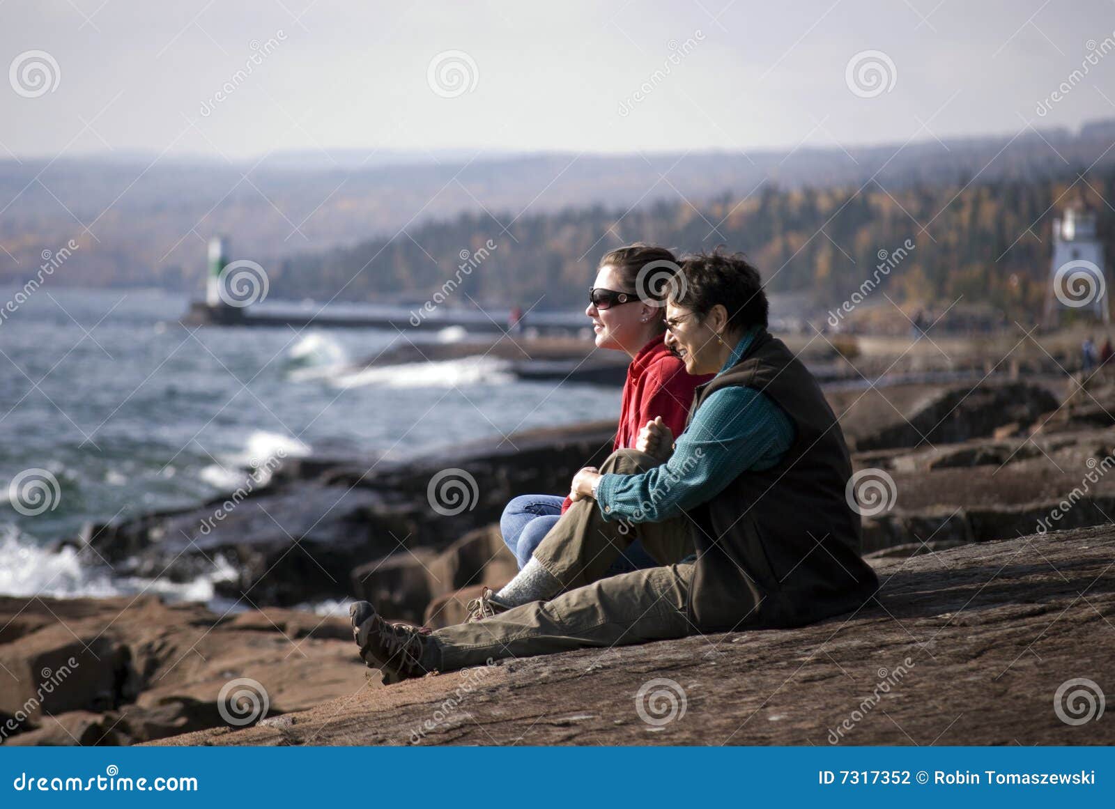 Women Sitting Near the Lake Stock Photo - Image of seashore, seated ...