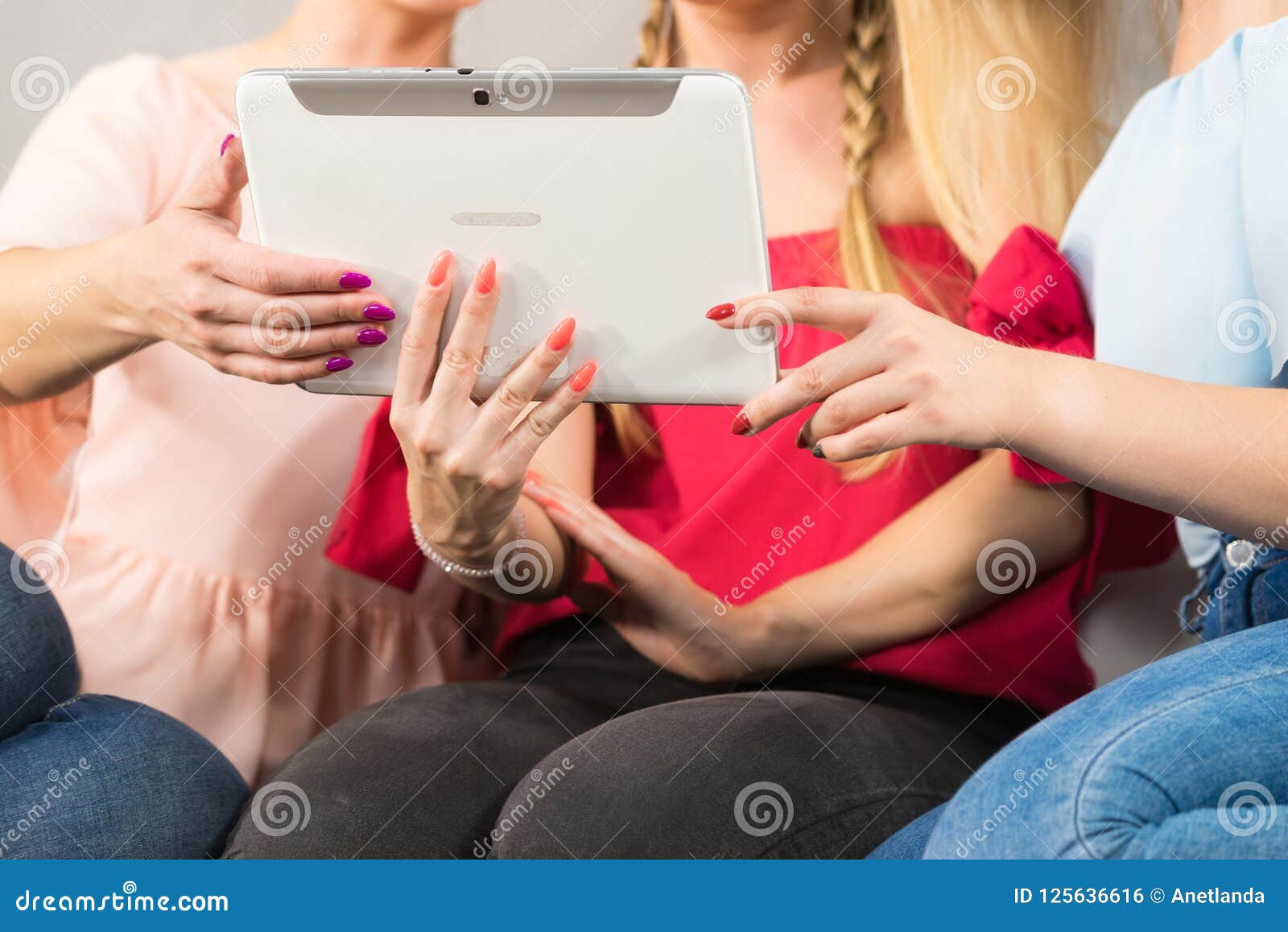 Three women using tablet stock photo. Image of touchscreen - 125636616