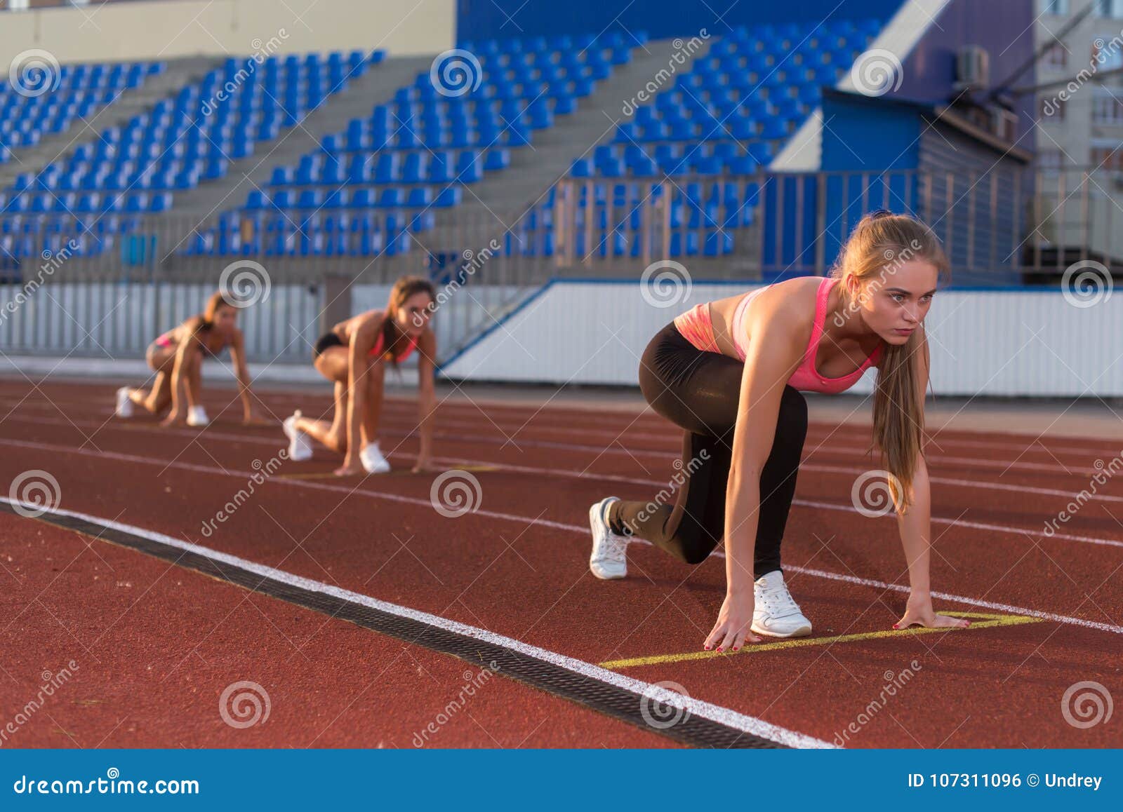 Women Sprinters at Starting Position Ready for Race on Racetrack. Stock ...