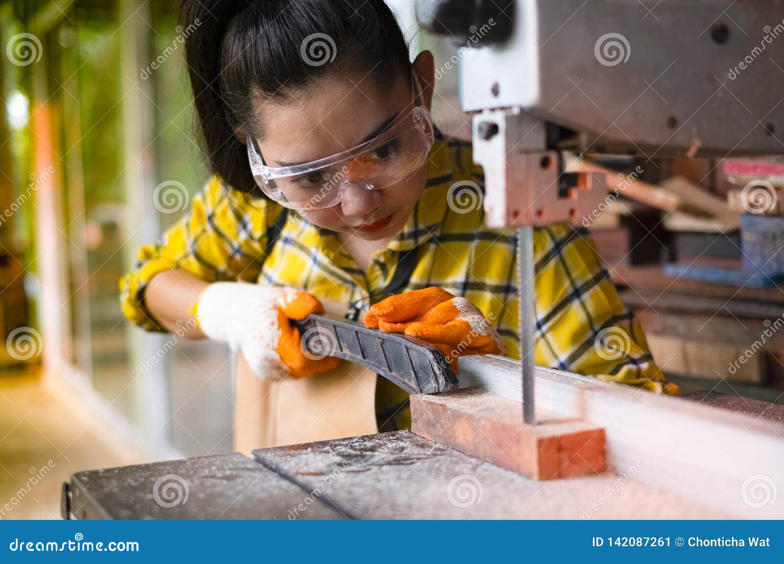 Women Standing is Craft Working Cut Wood at a Work Bench with Band Saws ...