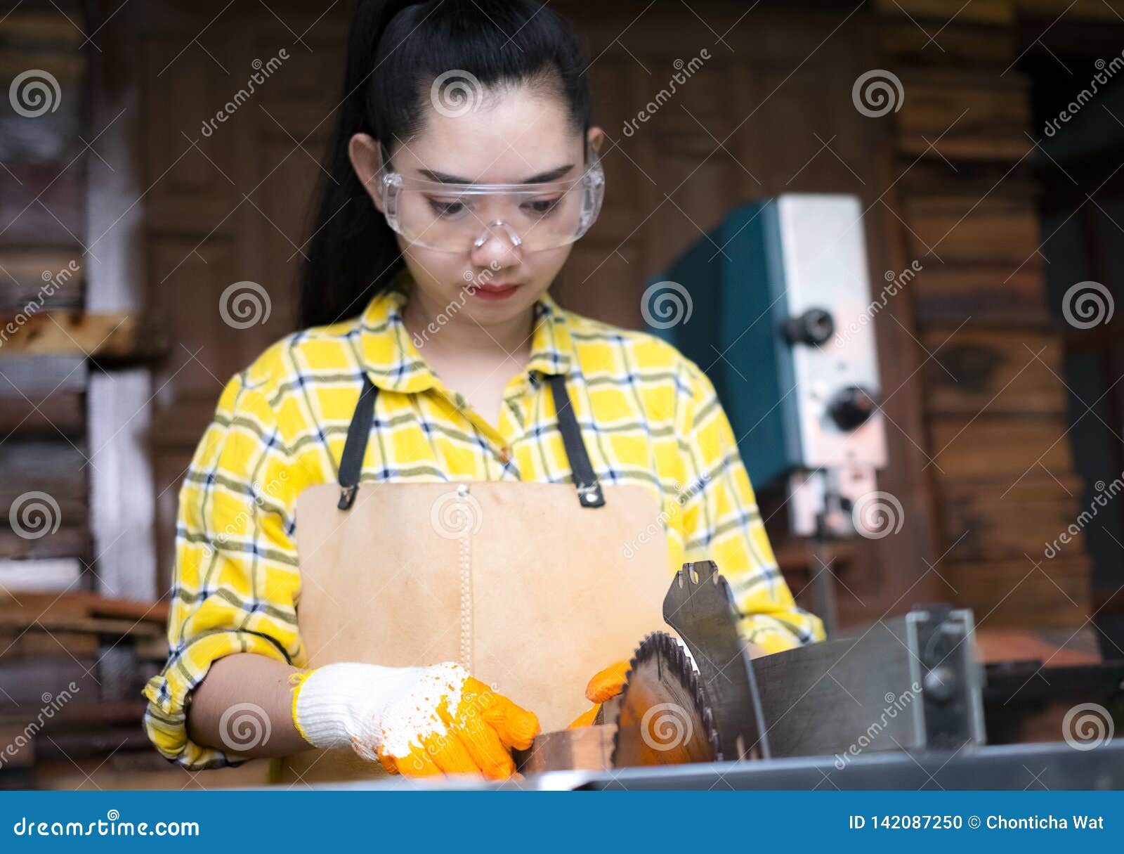 Women Standing is Craft Working Cut Wood at a Work Bench with Circular ...