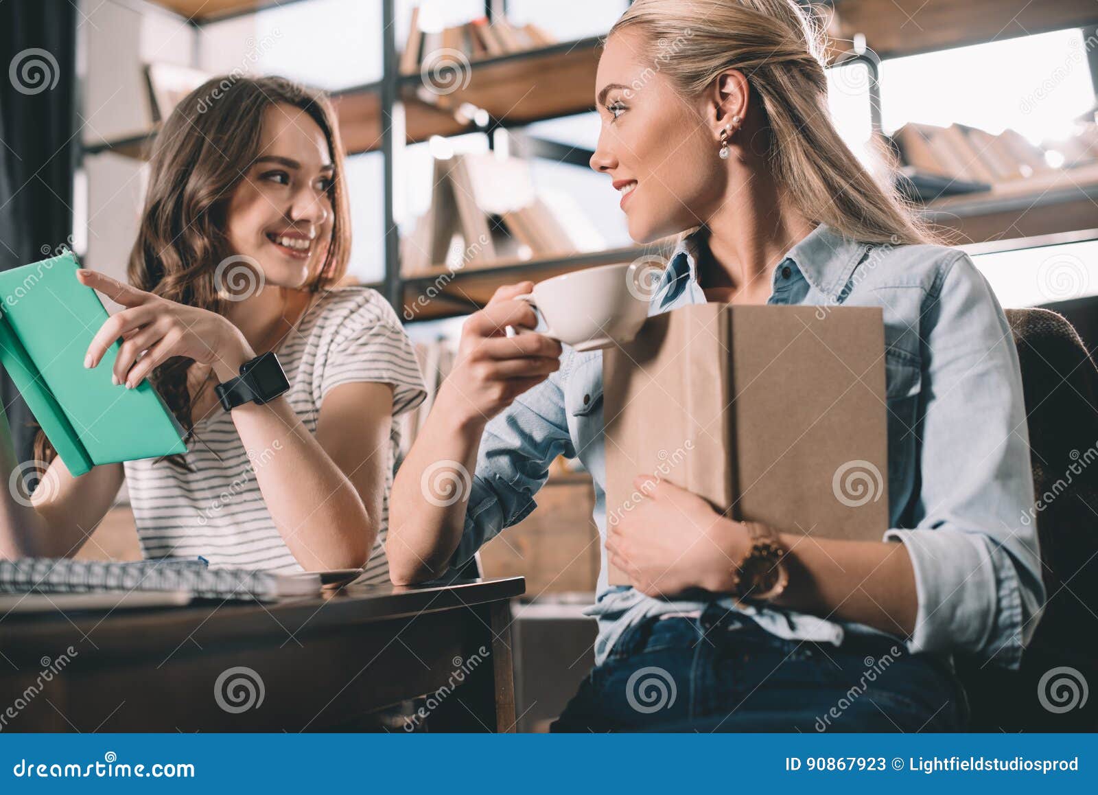 Women Students Having Conversation while Studying Together Stock Image ...