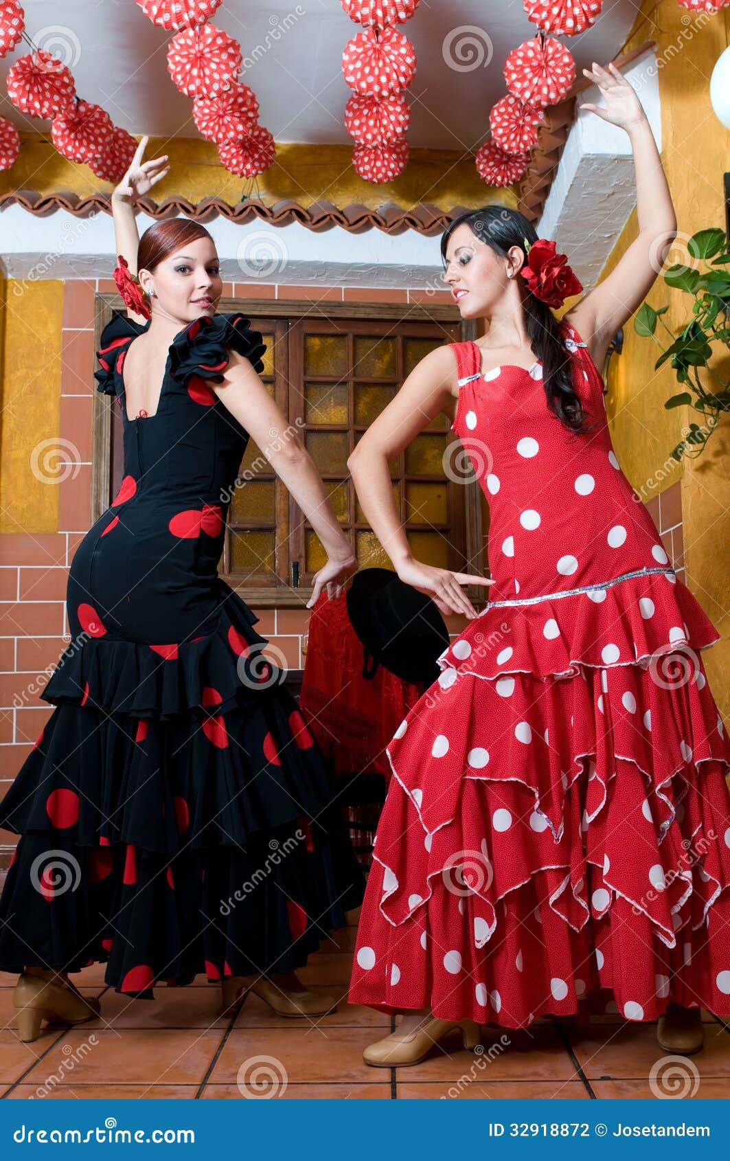 Women In Traditional Flamenco Dresses Dance During The Feria De Abril