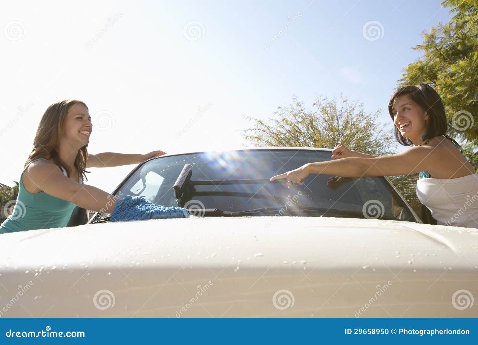 Women Washing Car Together stock photo. Image of hood - 29658950
