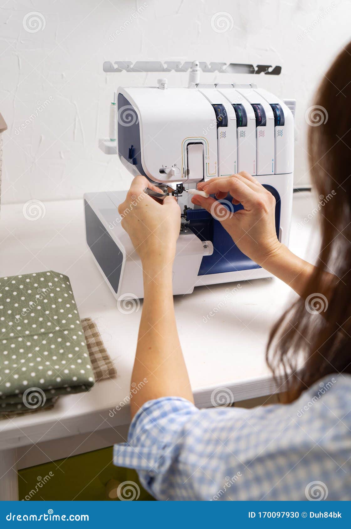 Girl Threading the Needle of a Sewing Machine. Stock Photo - Image of ...
