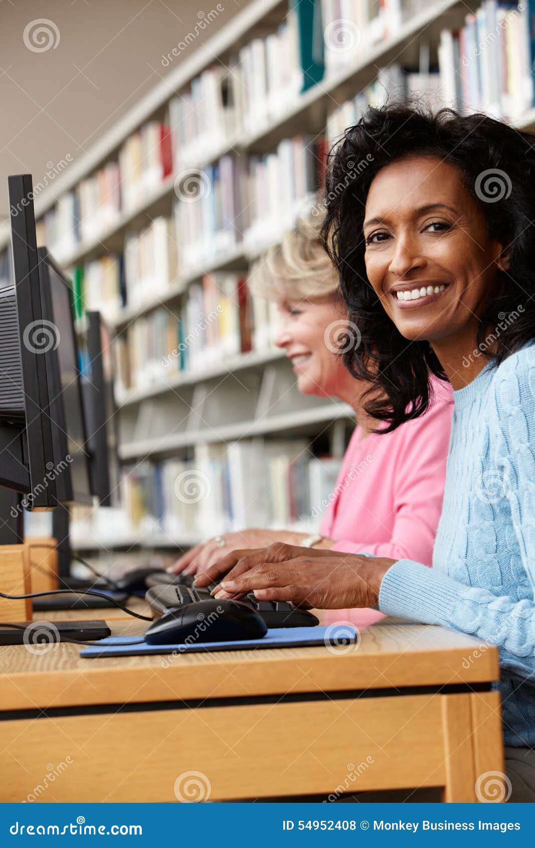 Women Working on Computers in Library Stock Photo - Image of college ...