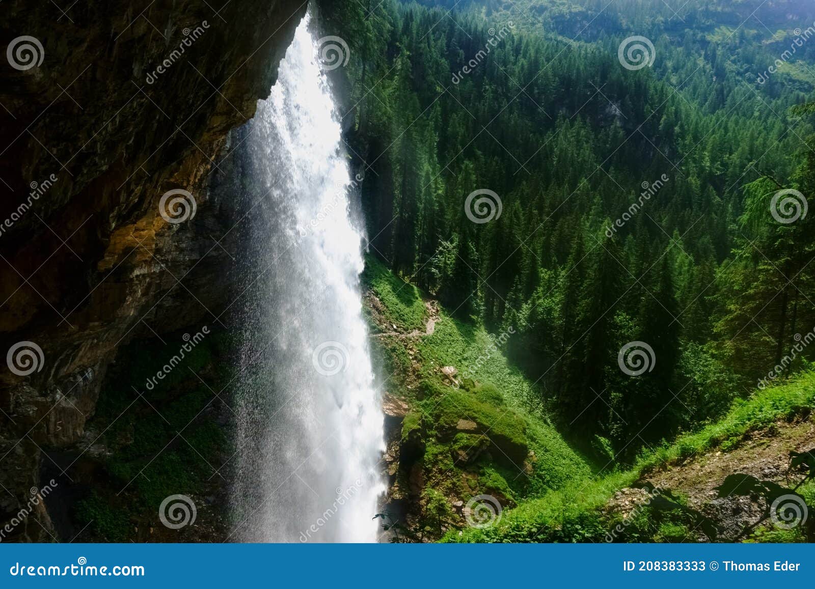 Wonderful High Waterfall Over a Cliff in the Mountains with a Forest ...