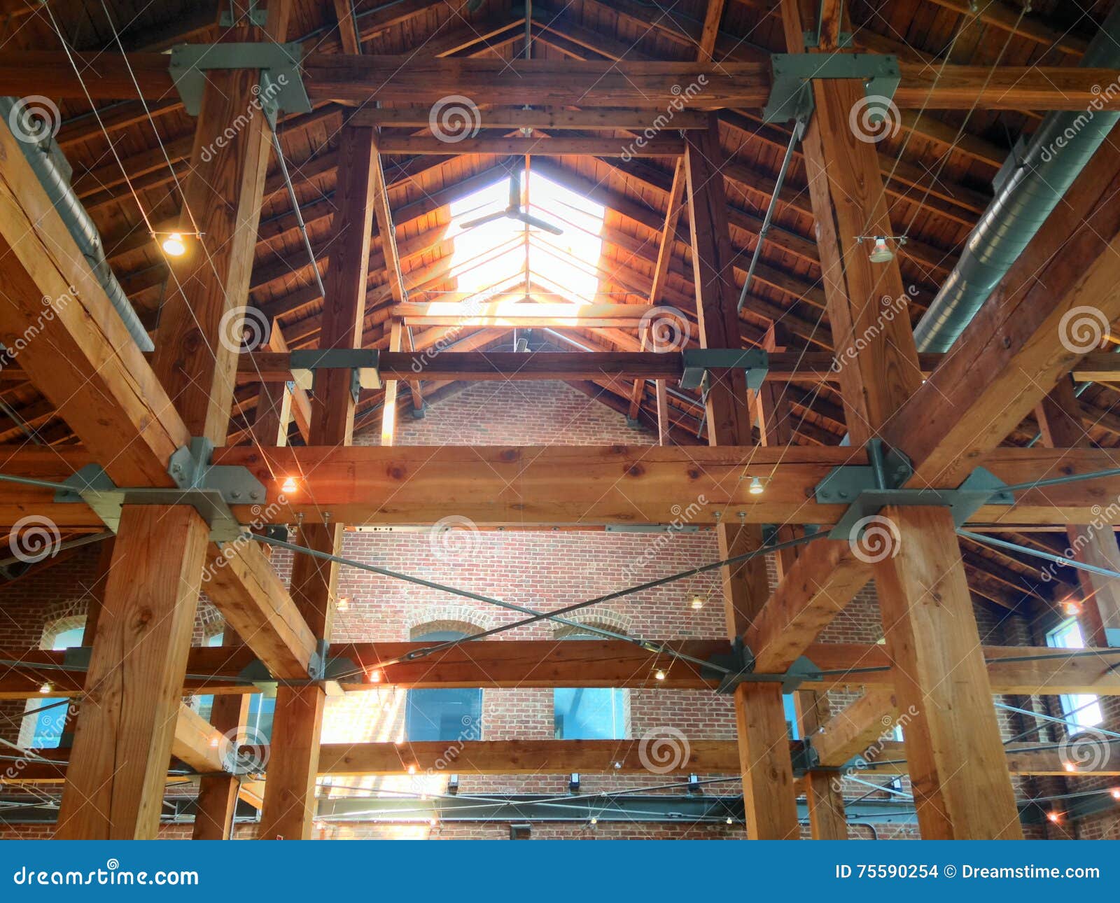 Wood Beams Outline the Inside of a Man Made Structure with Brick and ...