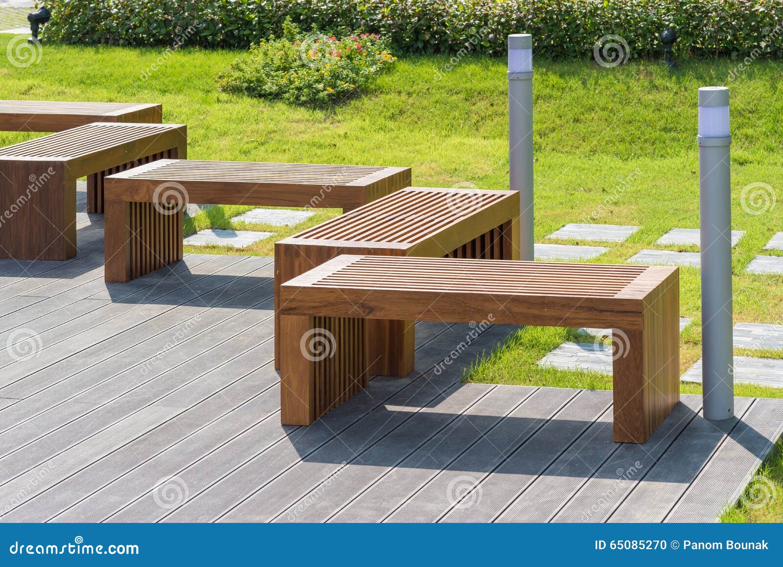 Wood Bench in Garden with Small Green Tree in Background Stock Photo ...