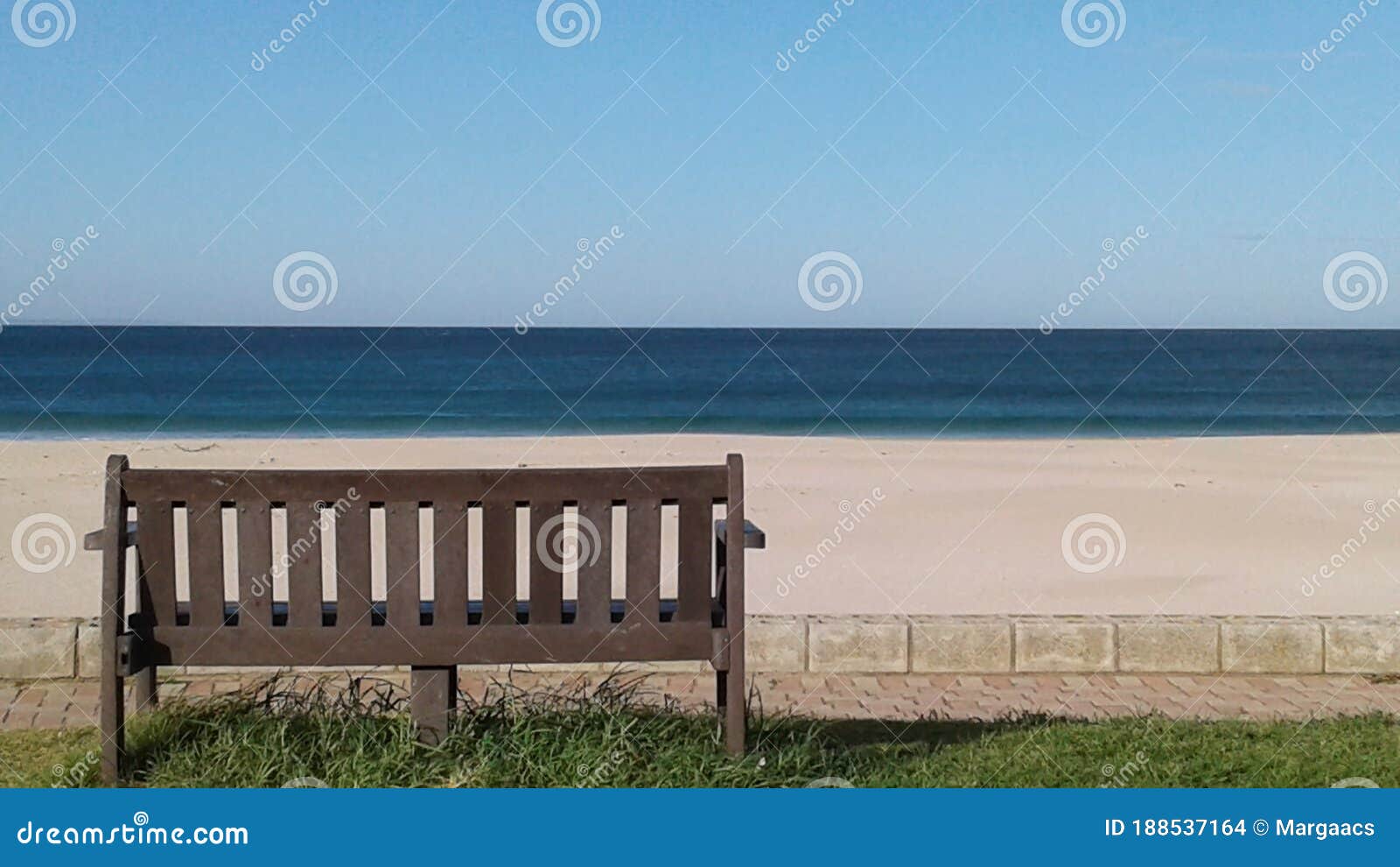 Wood bench on beach stock photo. Image of relax, infront - 188537164