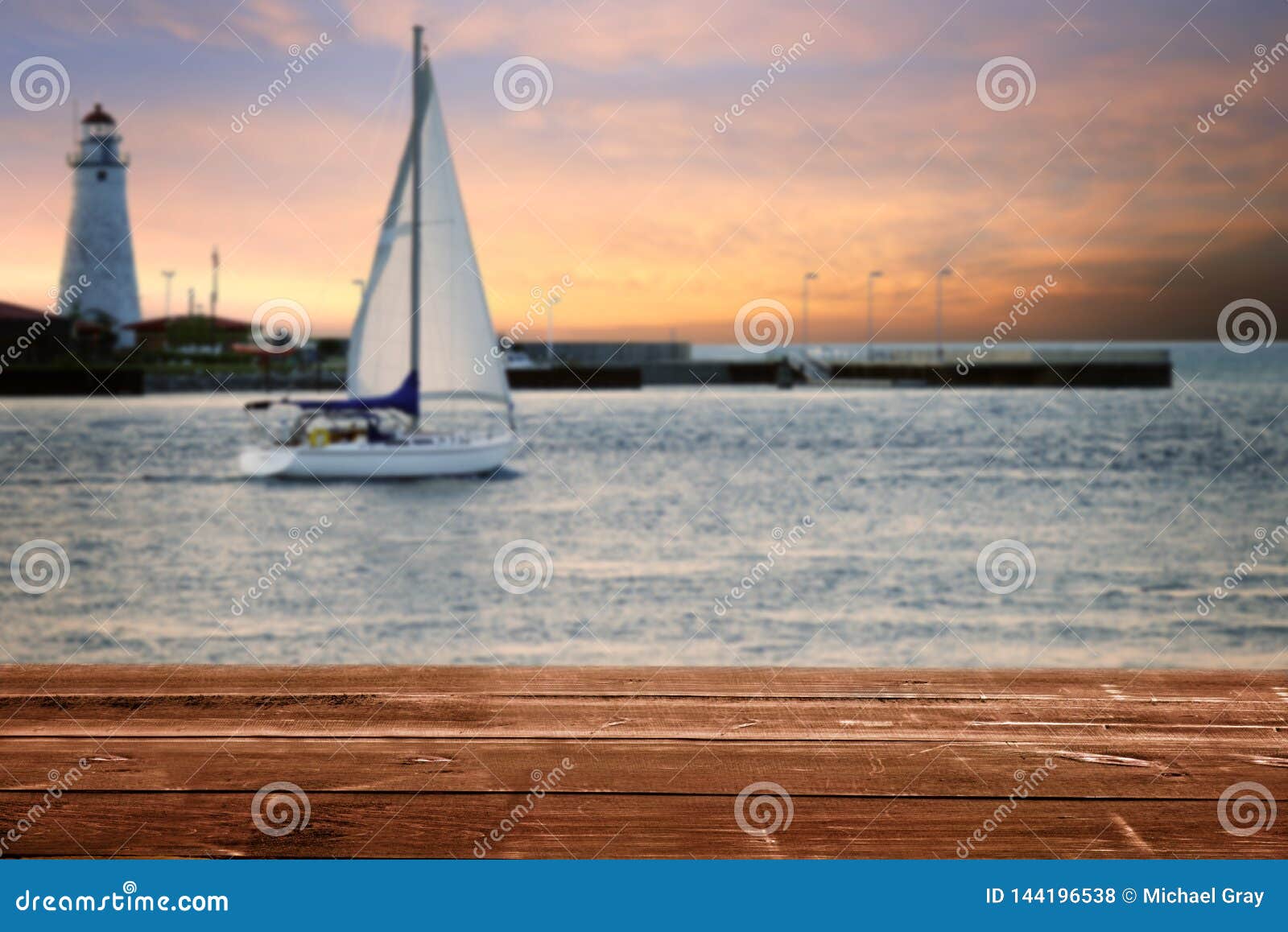 Wood Deck with Sailboat and Lighthouse at Sunset Stock Photo - Image of ...