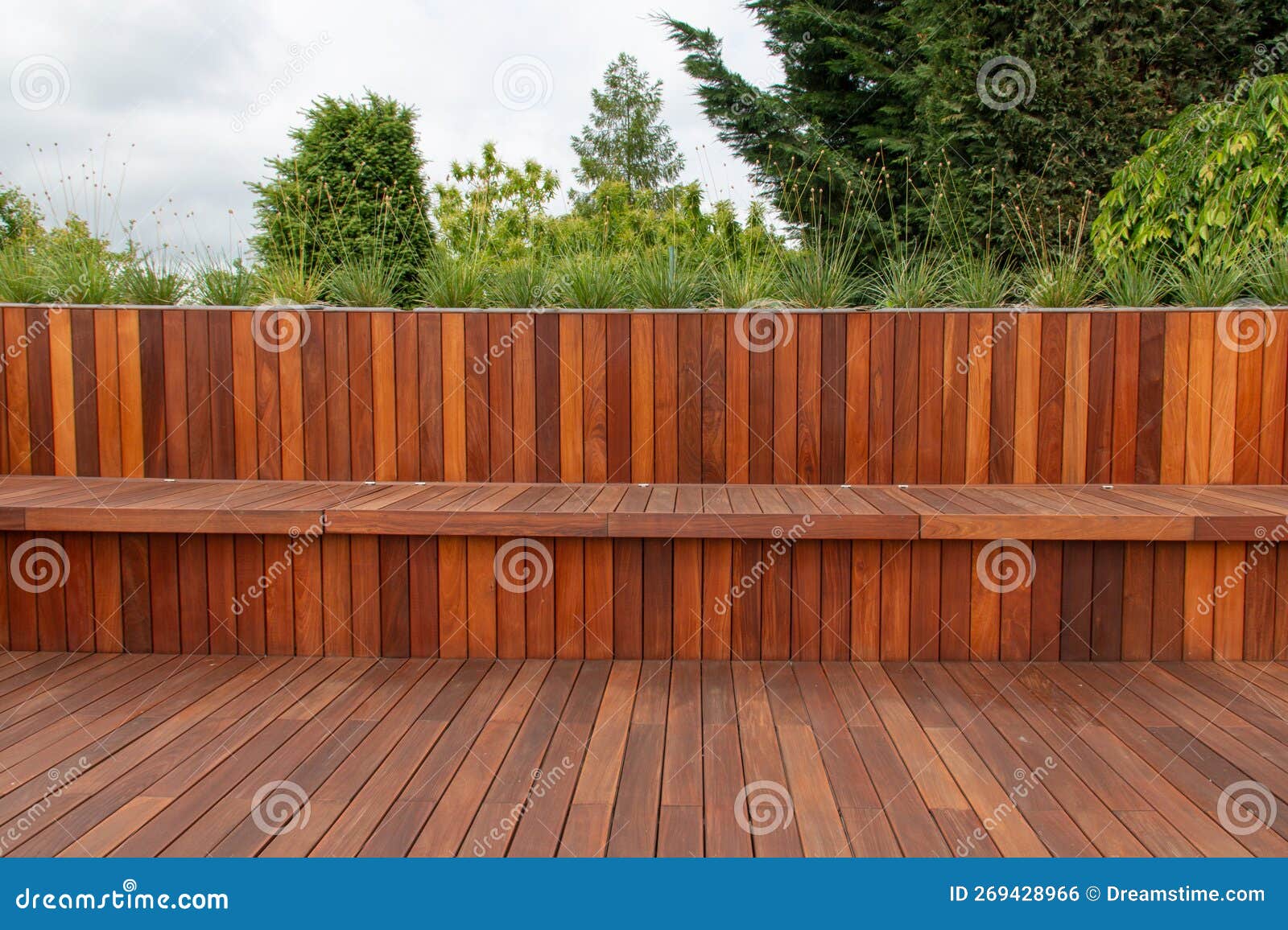 Wood Fence Cladding and Decking, Garden Greenery on the Background ...