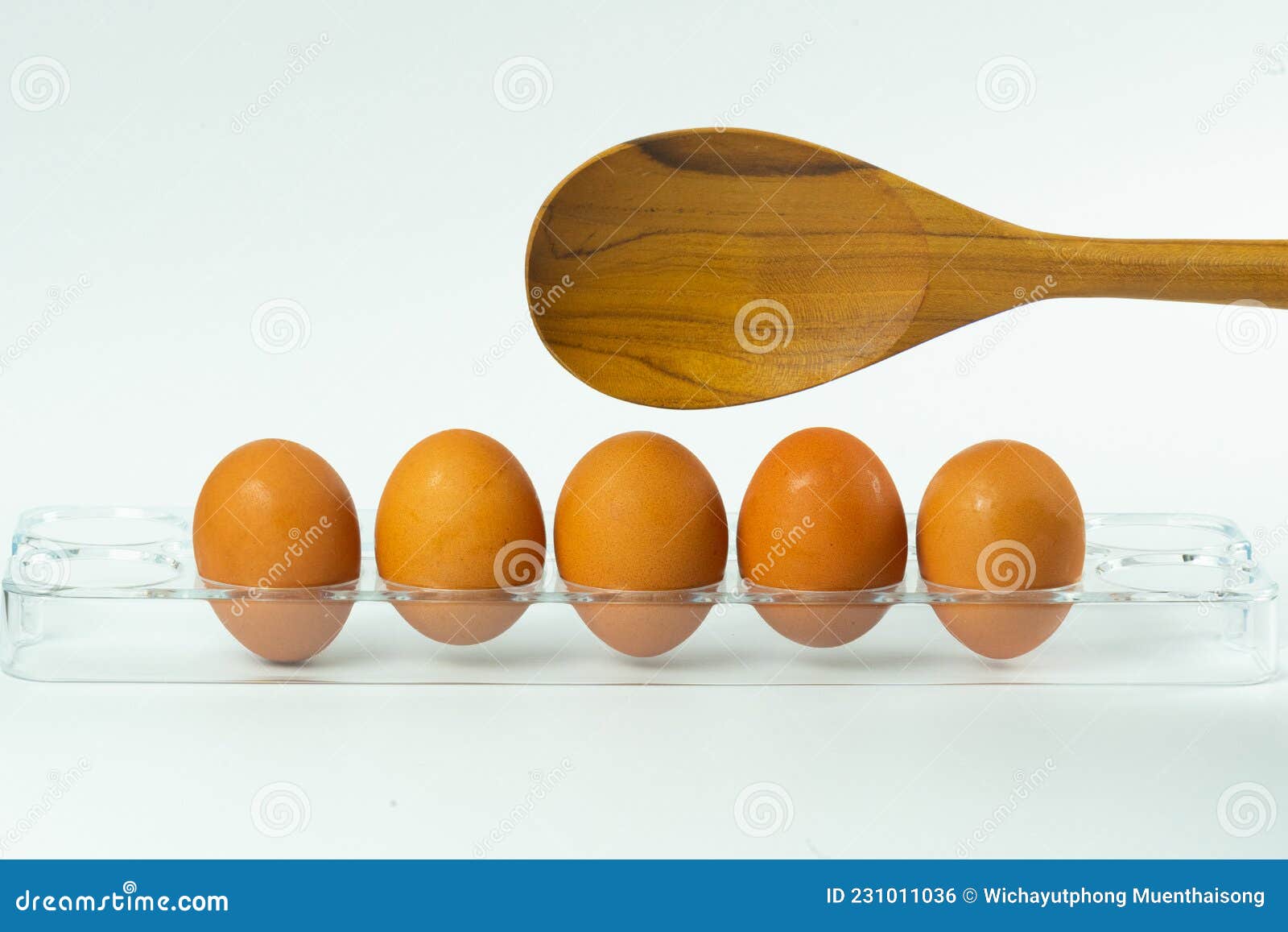 The wood ladle on the eggs stock photo. Image of showing - 231011036