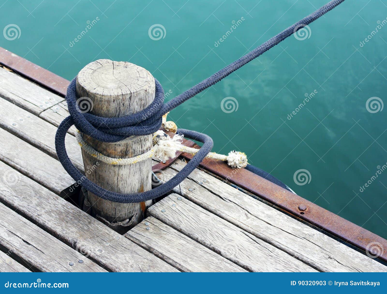 Wood Pile with Coiled Rope on the Dock Stock Image - Image of green ...