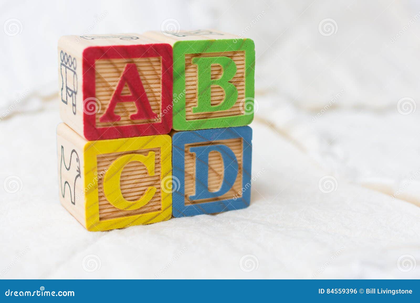 Wooden Alphabet Blocks on Quilt Spelling ABCD Stacked on Angle Stock ...